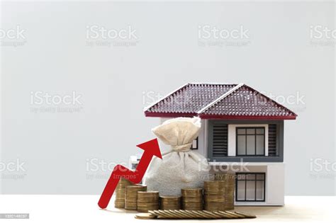 모기지 빨간 화살표 그래프와 흰색 배경에 모델 하우스와 동전 돈의 스택 비즈니스 투자 및 부동산 개념 0명에 대한 스톡 사진 및