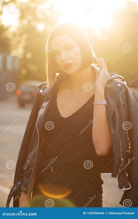 Gorgeous Brunette Model Wearing Black Leather Jacket Posing On A Street