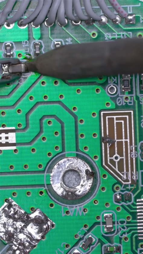Hand Holding Soldering Gun And Working With Lead Repair Board Electronic On Top View Male Hands