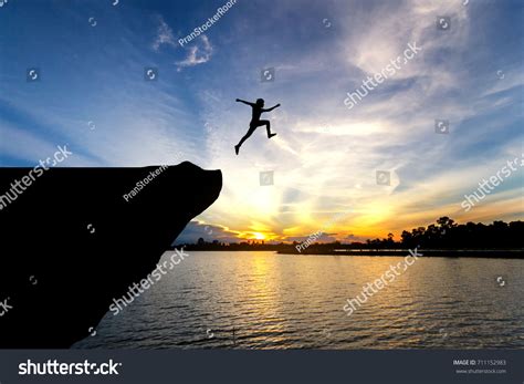 Man Jump Through Gap Between Hill Stock Photo 711152983 Shutterstock