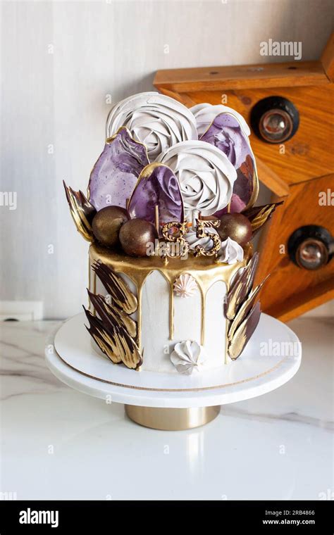 Elegant Grey And Golden Cake Decorated With Melted Chocolate Macaroons