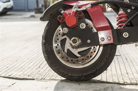 Detail Of The Rear Wheel And Disc Brake Of An Electric Scooter Parked