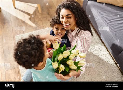 Joyous Pretty African American Woman Receiving Tulips From Her Cute