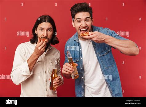 Photo Of Young Excited Guys Drinking Beer And Eating Pizza Isolated