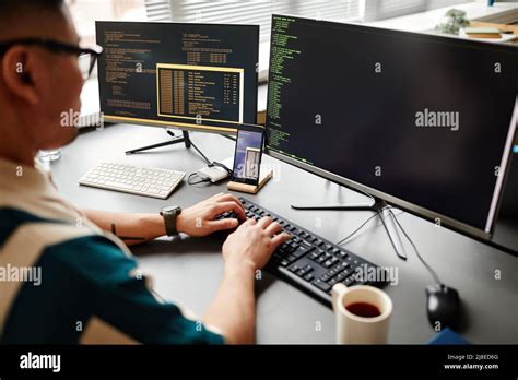 Closeup Of It Developer Typing On Keyboard With Programming Code On