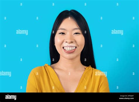 Beautiful Asian Woman Posing Over Blue Background Stock Photo Alamy