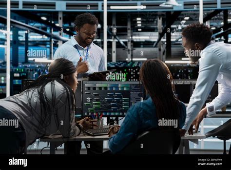 Engineering Team Programming In Ai Data Center Housing Advanced Equipment Used For Machine