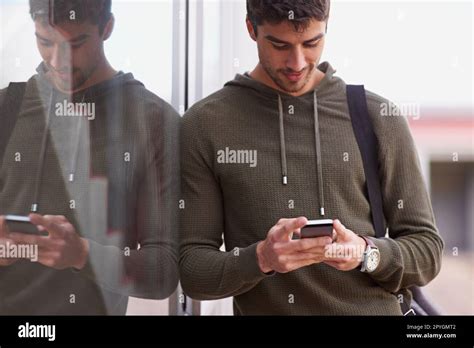 Catching Up After His Exam A Handsome Young Man Using His Cellphone On