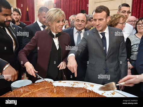French President Emmanuel Macron Right And His Wife Brigitte Macron Cut Slices Of A