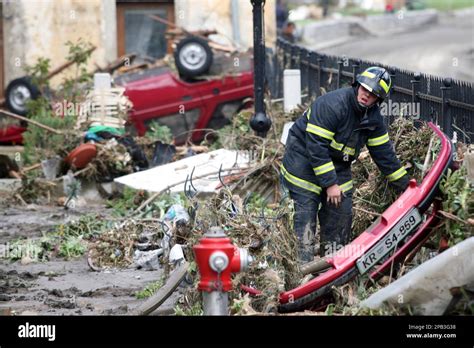 A Slovenian Firefighter Clears The Parts Of A Car Wrecked After Floods