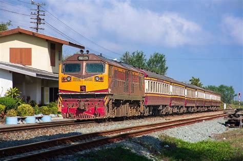 Passenger Train By Diesel Locomotive Was Arriving The Station Stock