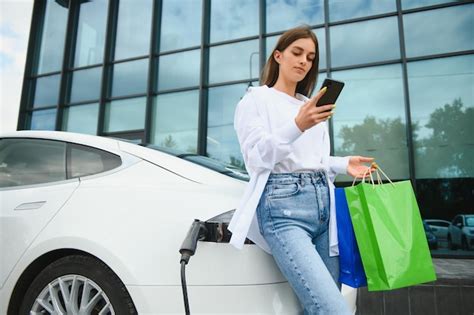 Premium Photo Girl Charging Electro Car At The Electric Gas Station