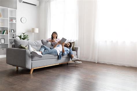 Premium Photo Candid Shot Of Eastern Couple Chilling On Couch Using