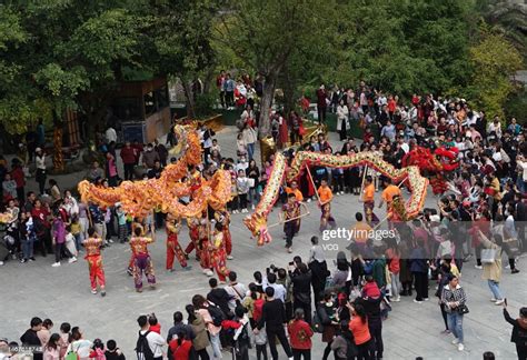 Tourists Watch As Folk Artists Performing Dragon Dances At A Scenic