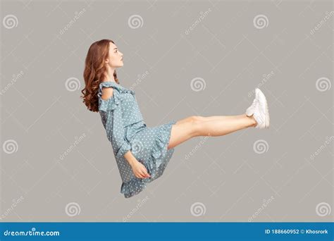 Hovering In Air Full Length Side View Of Calm Serious Brunette Pretty
