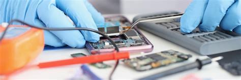 Premium Photo Master Repairman Inserting Microchip Into Mobile Phone Closeup
