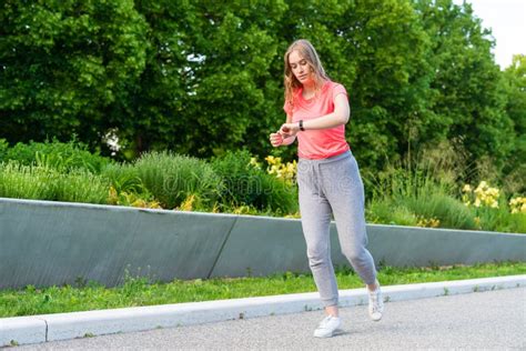 Woman Is Jogging In The Park And Checks Her Puls Stock Image Image Of