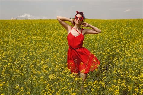 Premium Photo Sexy Young Woman In A Short Red Dress Stands In A Field