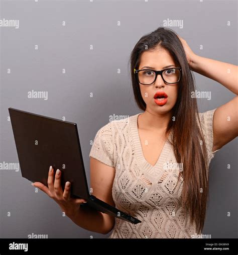 Portrait Of Woman In Shock What She Sees At Her Laptop Against Gray