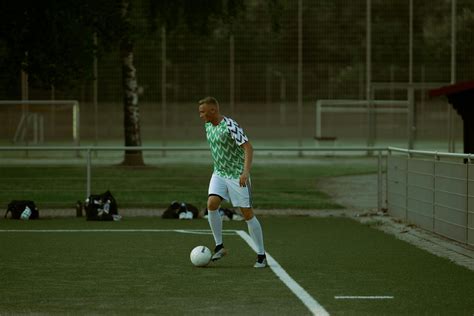 Man Wearing Black Crew Neck Shirt And Black Shorts Lying On Green Grass