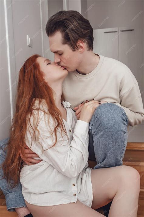 Premium Photo Couple In Love Kissing On Wooden Stairs A Redhaired