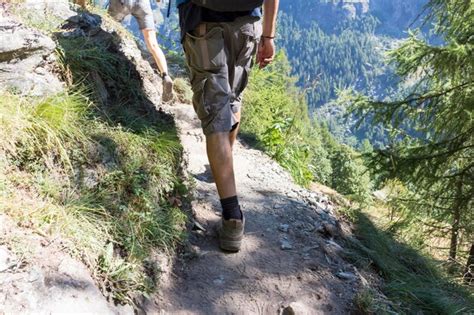 Premium Photo Low Section Of Man Hiking On Mountain Trail