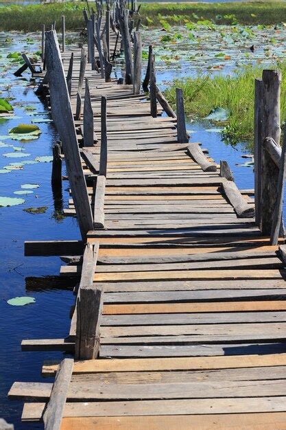 Premium Photo Wooden Bridge On Water