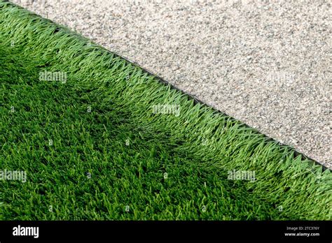Closeup Installation Of Football Field With Artificial Turf With Grass