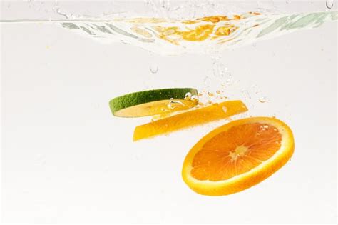 Premium Photo Fruit Slices Dropped Into Water