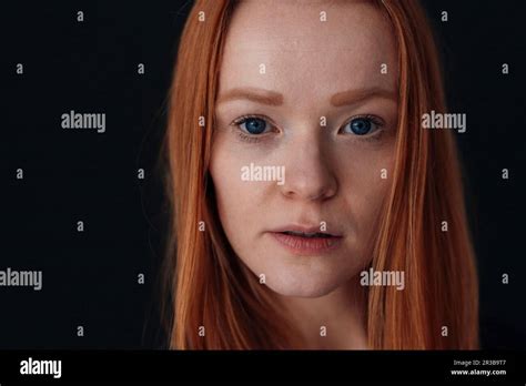 Redhead Woman Against Black Background Stock Photo Alamy