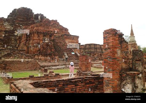 Female Traveler Being Impressed With The Massive Temple Ruins Of Wat