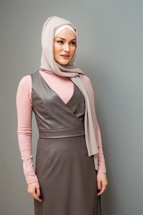 Sad Crying Muslim Woman In Hijab Is Sitting On The Sofa At Home Stock