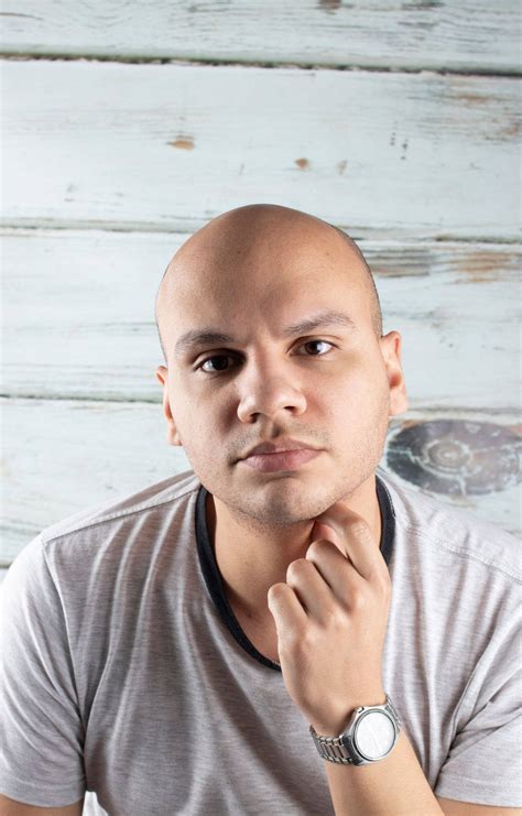 Download Bald Man Wearing A Gray Shirt Wallpaper