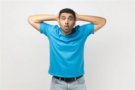 Premium Photo Shocked Man Looking At Camera With Big Eyes Keeps Hands