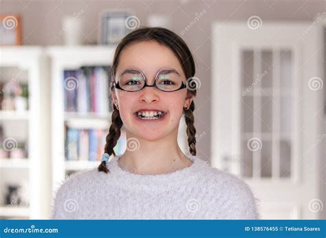 Portrait Of Funny Attractive Smiling Preteen Girl With Pigtails And