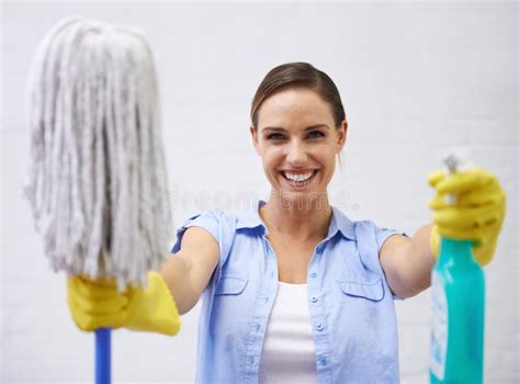 Lets Get Your Hands Dirty A Smiling Woman Holding Out A Mop And Spray