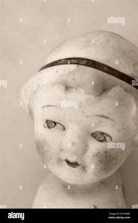 Sepia Image Of Head Of 1920 Porcelain Girl Doll With Big Eyes And