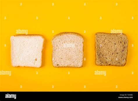 Three Different Types Of Toast Bread White Grain And Brown On A Bright Yellow Background Top