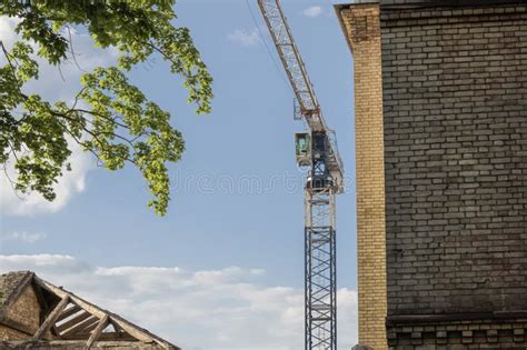 Yellow Brick Building Corner With Wooden Rooftop And The Contruction