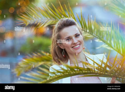 Portrait Of Smiling 40 Years Old Woman In Pink Dress And White Jacket