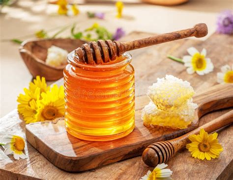 Natural Organic Honey In Glass Jar Honey Dipper And Honeycombs Are