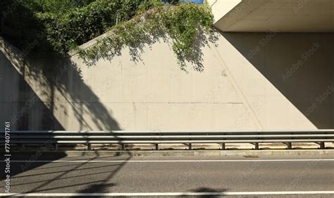 Metallic Guardrail On Sidewalk Concrete Wall Of An Underpass With