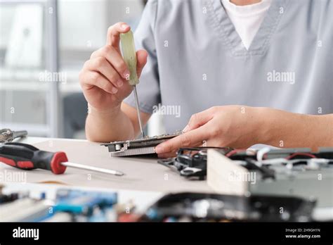 Hands Of Female Troubleshooting Technician Fixing Tiny Details Of
