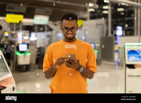 Young Handsome Black Man Ready To Travel At Airport Terminal Waiting