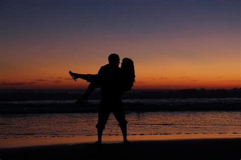 Premium Photo Silhouette Couple Standing At Beach During Sunset