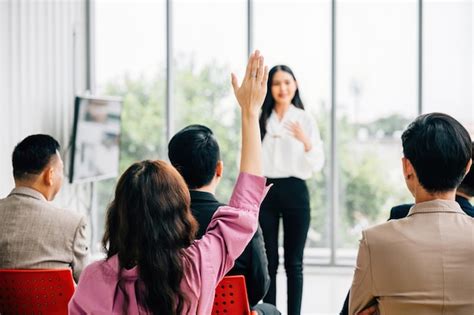 Premium Photo A Large Group In A Seminar Classroom Raises Their Hands Actively Participating