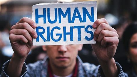 Hands Of A Young Man Holding Human Rights Sign Dramatic Closeup With