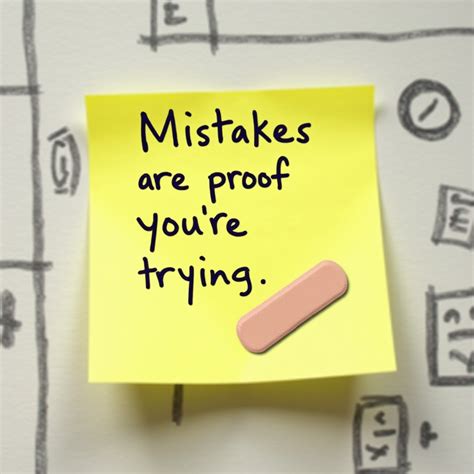 Photograph Of A Yellow Office Post It Note On A Random Office Desktop