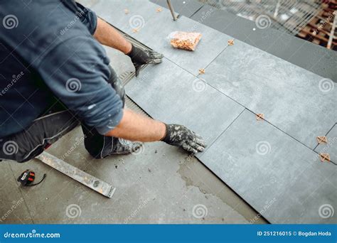Professional Tiler And Ceramic Tiles Worker On Construction Site Stock