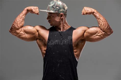 Muscular Man In Gym Showing Biceps Muscles Strong Male Stock Photo